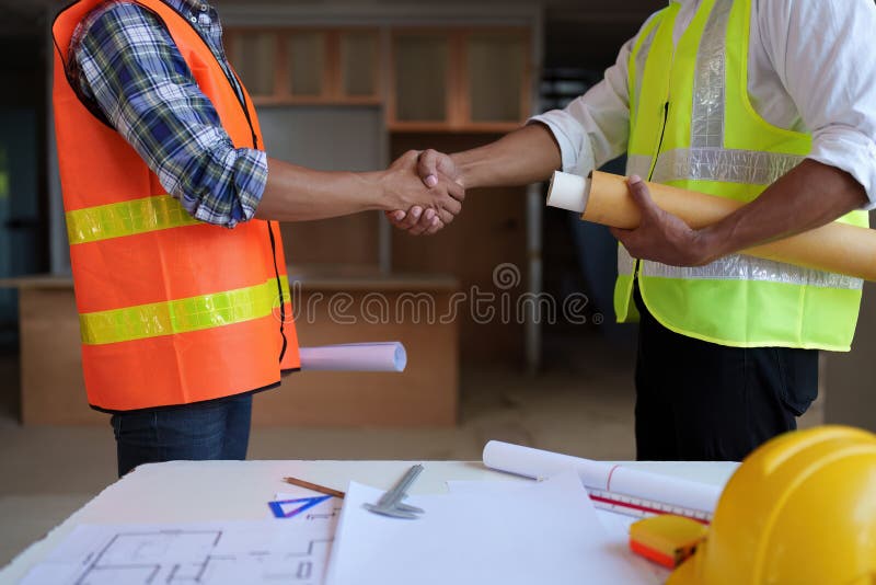 Architect and Engineer Construction Workers Shaking Hands after Finish ...