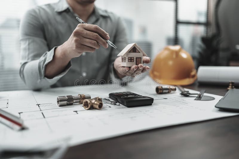 Architect Engineer Hands Hold and Protect Mini House Model on Blueprint ...