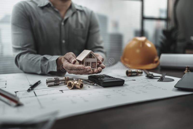 Architect Engineer Hands Hold and Protect Mini House Model on Blueprint ...