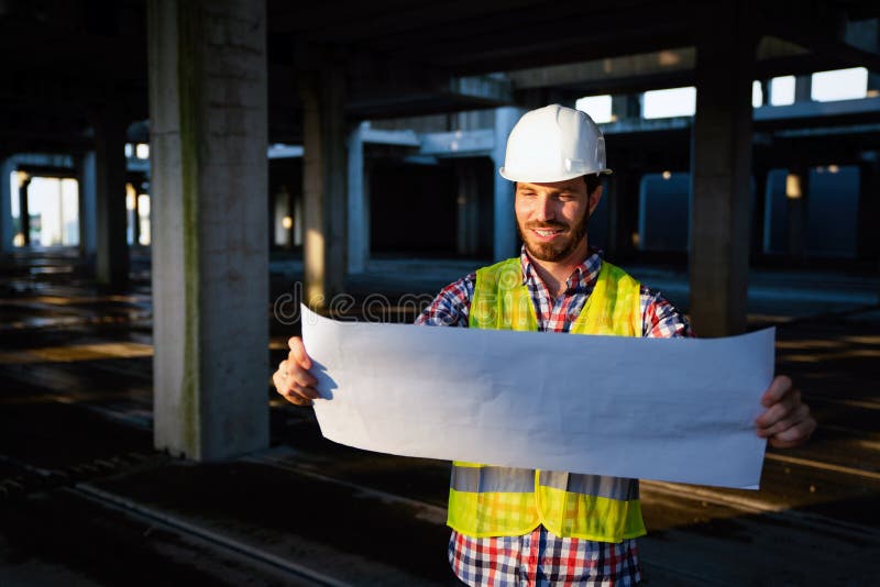 Architect, Engineer Looking at Blueprints in a Construction Site Stock ...