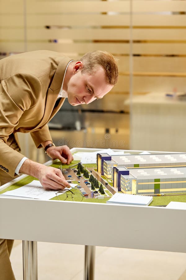 Concentrated Architect Man Working with Building Layout, Architectural ...
