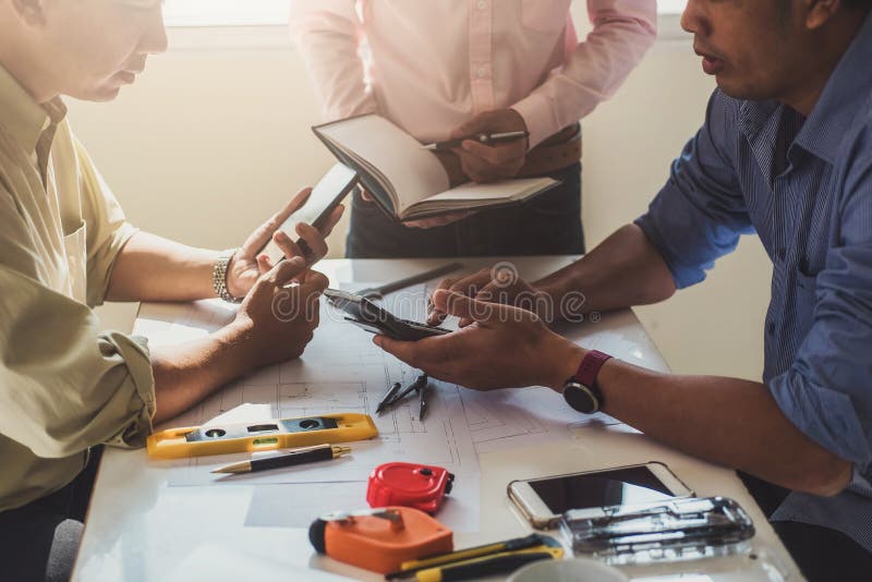 Architect or Engineer Reading Message on Phone during the Meeting ...