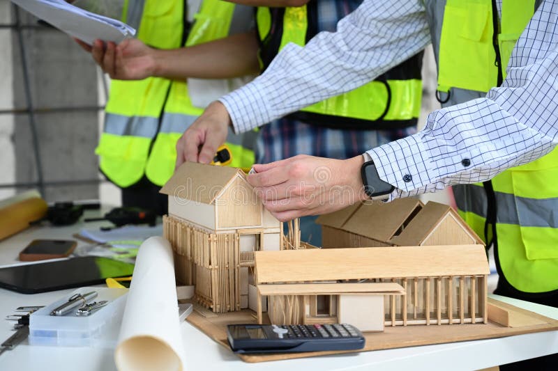 Architect and Engineer Team Discussing about about Design Building at ...