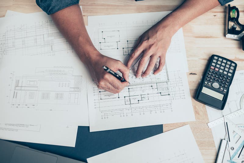 Architect Engineer Use Pen Drawing Design Working on Blueprint. House Planning Design and ...