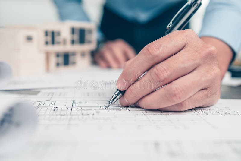 Architect Engineer Use Pen Drawing Design Working on Blueprint. House Planning Design and ...