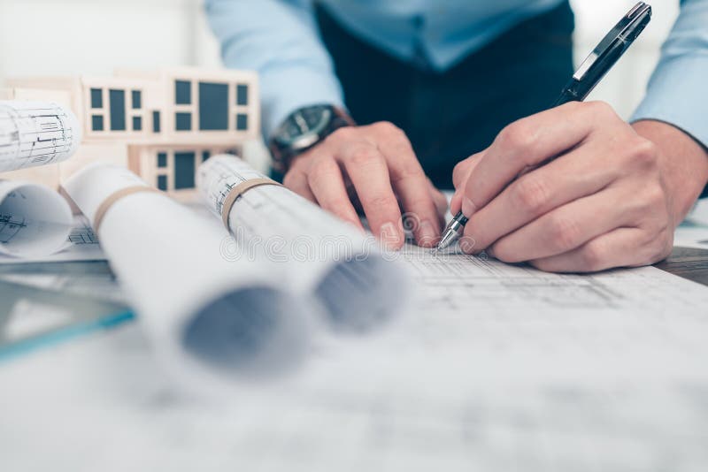 Architect Engineer Use Pen Drawing Design Working on Blueprint. House Planning Design and ...