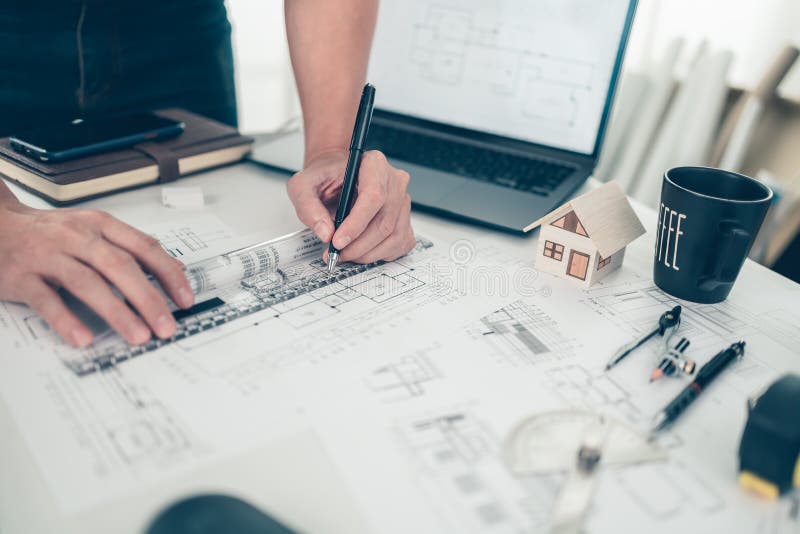 Architect Engineer Use Pen and Mini T-slide Drawing Design Working on Blueprint. House Planning ...