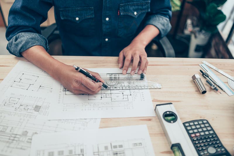 Architect Engineer Use Pen and Mini T-slide Drawing Design Working on Blueprint. House Planning ...