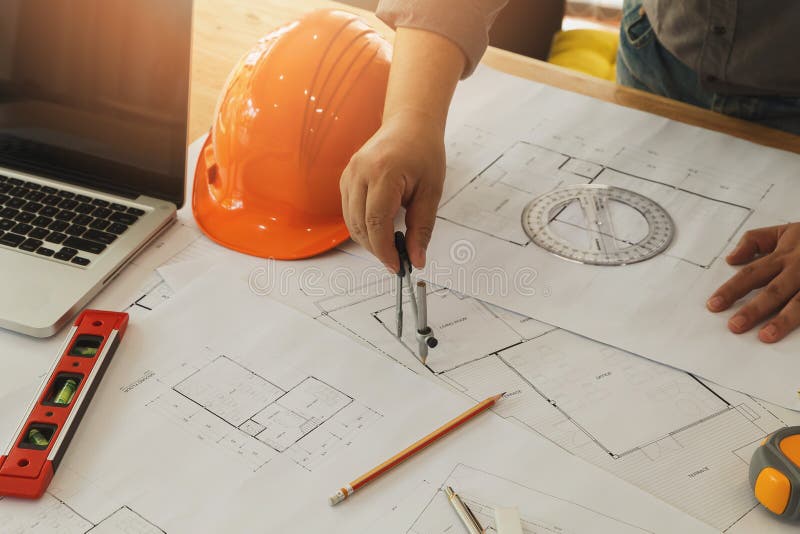 An Architect or Engineer Uses a Divider Gauge on the Blueprint ...