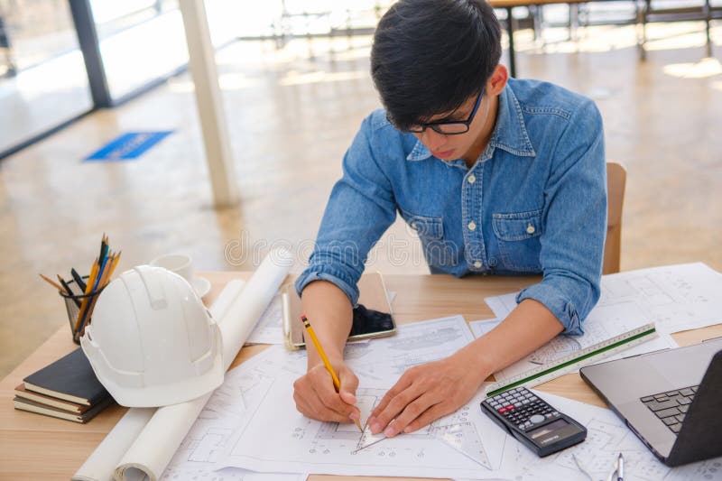 Architect and Engineer Using a Compass To Design House Plans at a Work ...