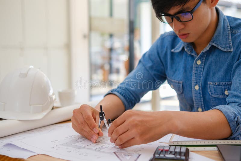 Architect and Engineer Using a Compass To Design House Plans at a Work ...