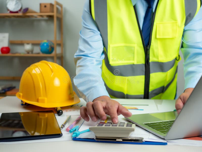 Architect or Engineer Using Computer To Work on Desk, Cost Calculation ...