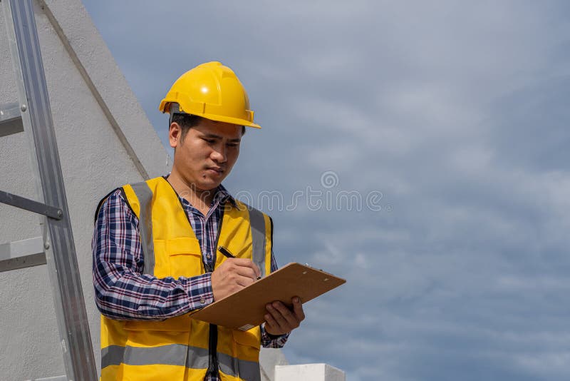 An Architect Engineer in a Work Uniform with a Construction Helmet and ...