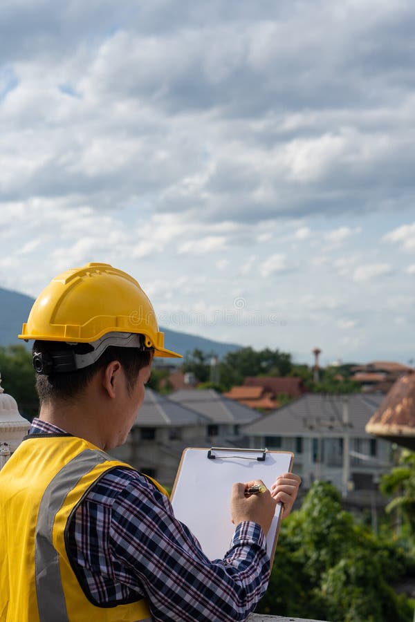 An Architect Engineer in a Work Uniform with a Construction Helmet and ...