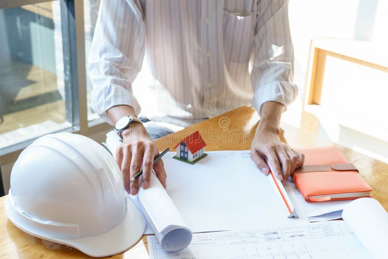 Architect or Engineer Working on Blueprint at Workplace on Wooden Desk ...