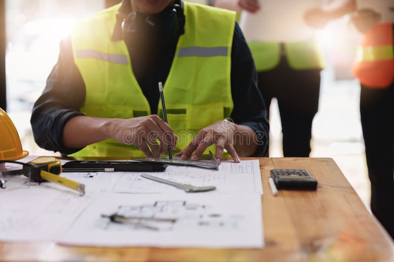 Architect and Engineer Working with Blueprints for Architectural Plan ...