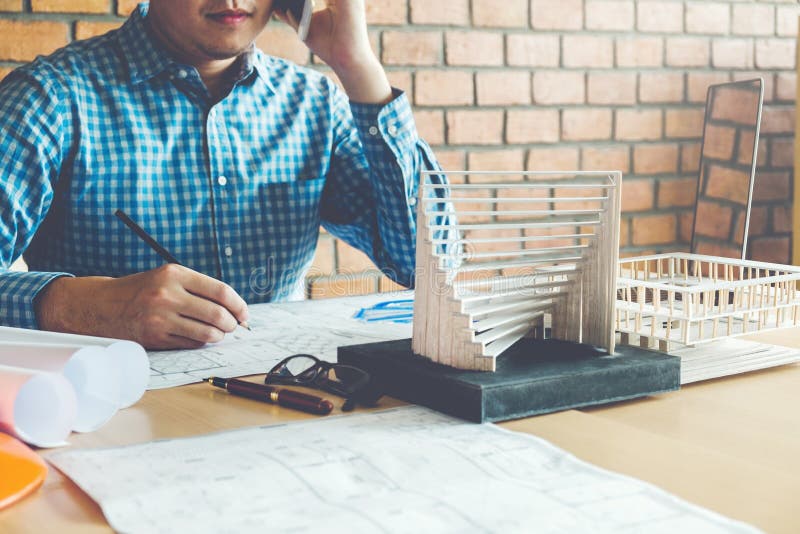 Architect or Engineer Working in Office on Blueprint. Architects ...