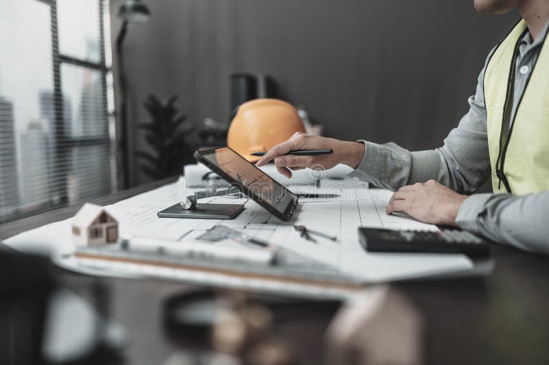 Architect, Engineering Working with House Drawings Inspection on Tablet ...