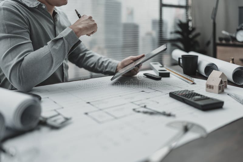 Architect, Engineering Working with House Drawings Inspection on Tablet ...