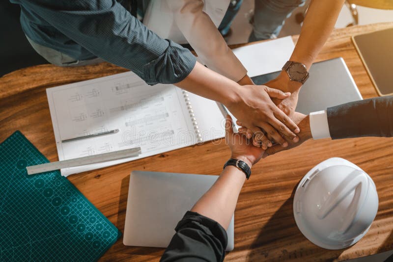 Architect with Engineers are Helping To Design Work on Blueprints and ...