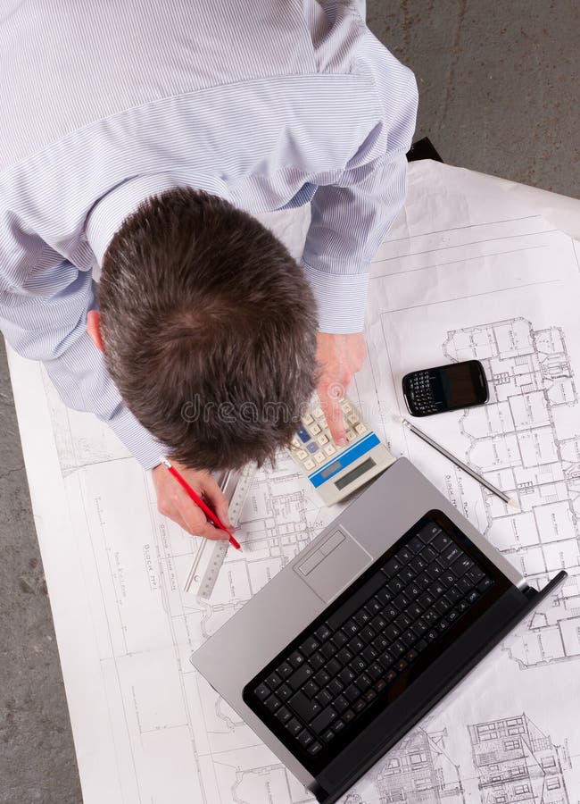 Male Architect with Digital Tablet Studying Plans in Office Stock Photo ...