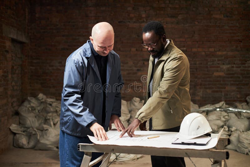 Architect and Foreman Looking at Project on Paper Stock Photo - Image ...