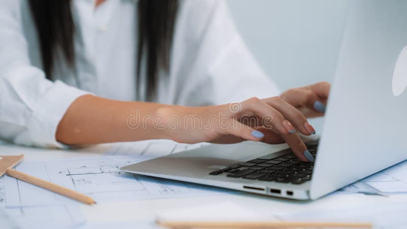 Architect Hand Using Laptop with Blueprint Placed on Table. Closeup ...