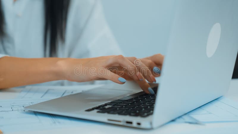 Architect Hand Using Laptop with Blueprint Placed on Table. Closeup ...