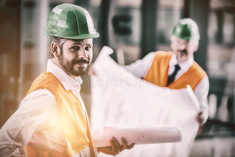 Architect in Hard Hat Standing with Blueprint in Office Corridor Stock ...