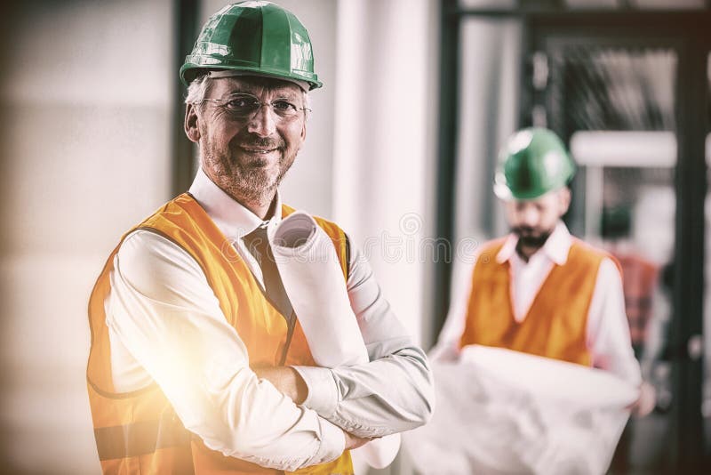 Architect in Hard Hat Standing with Blueprint in Office Corridor Stock ...