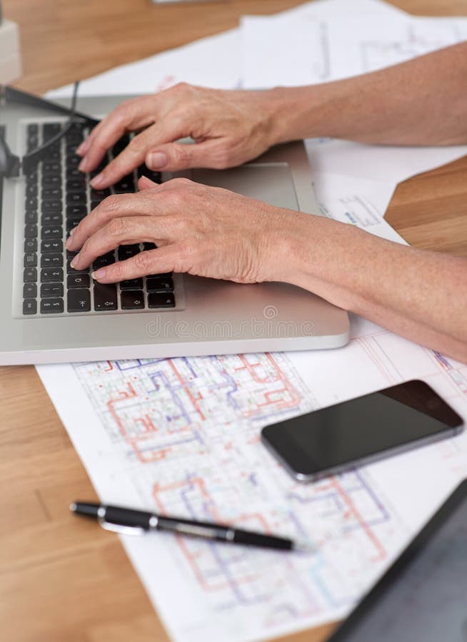 Architect and Her Tech. Cropped Image of an Architect Working on Her ...