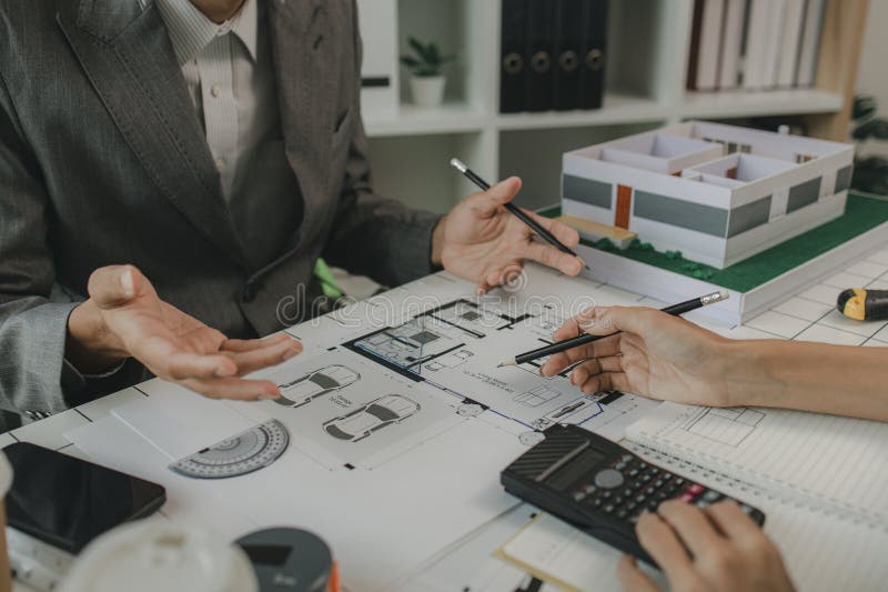 An Architect and His Assistant are Brainstorming and Examining the ...