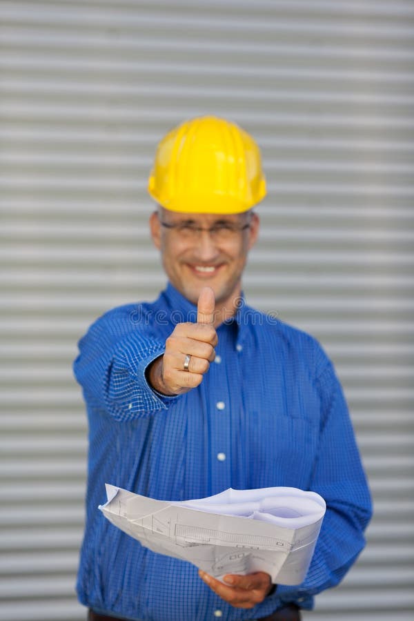 Architect Holding Blueprint while Gesturing Thumbs Up Stock Photo ...
