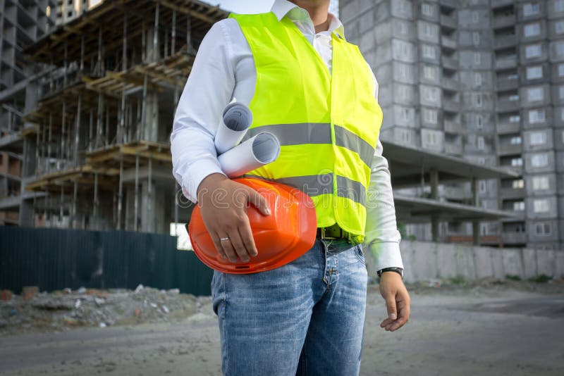 Architect in Jacket Posing with Red Helmet at Construction Site Stock ...