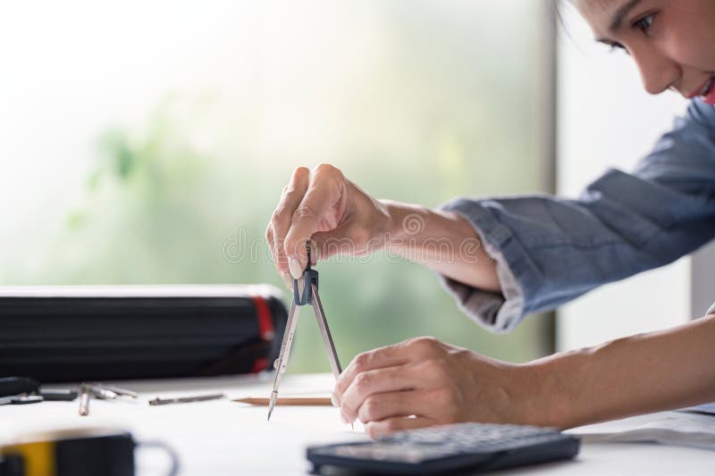 Architect Leveraging a Compass for Geometry in Innovative Construction ...