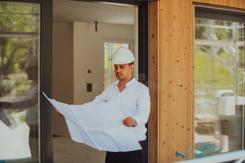 A Architect Looking at Plan and Thinking about Working on Big Project ...