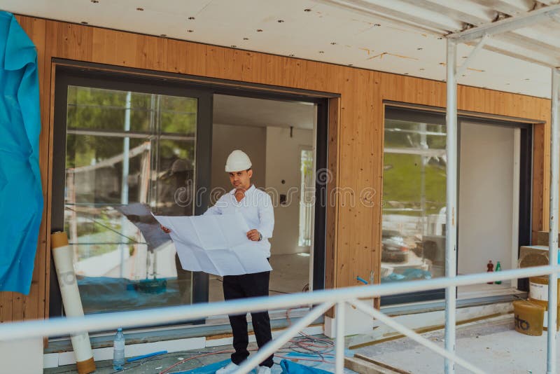 A Architect Looking at Plan and Thinking about Working on Big Project ...