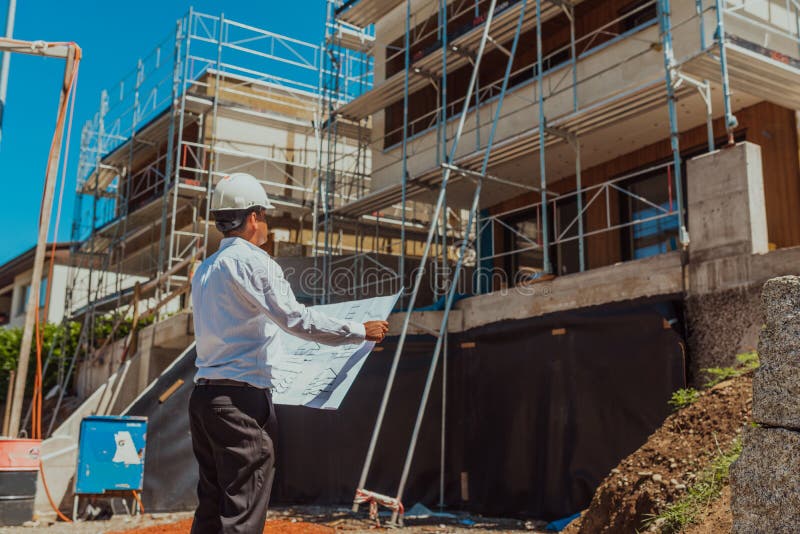 A Architect Looking at Plan and Thinking about Working on Big Project ...