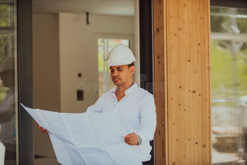 A Architect Looking at Plan and Thinking about Working on Big Project ...
