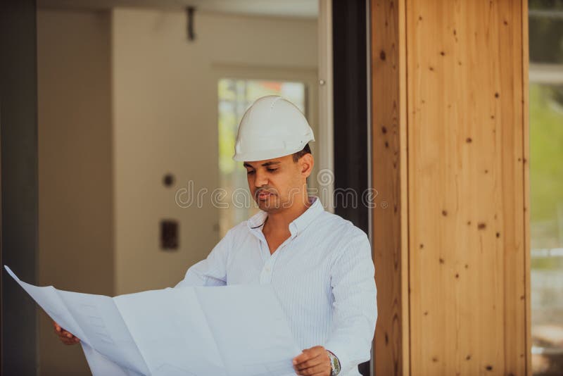 A Architect Looking at Plan and Thinking about Working on Big Project ...