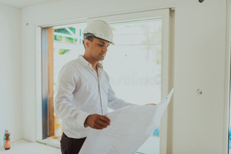 A Architect Looking at Plan and Thinking about Working on Big Project ...