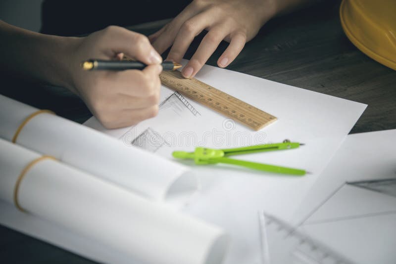 The Architect Makes Measurements on Papers. Building Plan Stock Photo ...