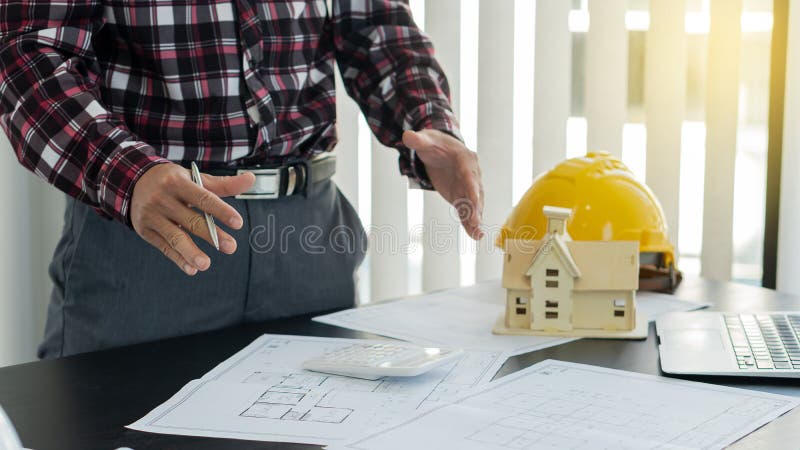 An Architect or Male Engineer Working at Home, Drawing Up a ...