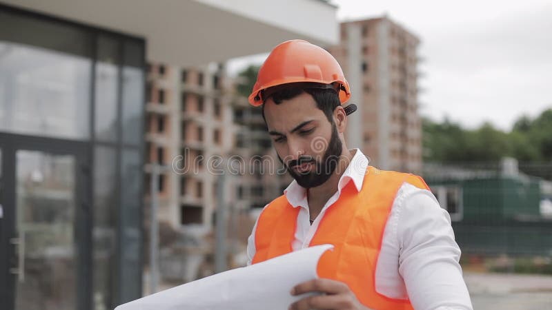 Architect Man Walking on the Construction Site and Analyzing Scheme ...