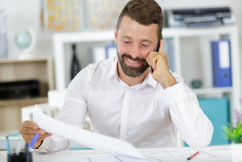 Architect in Office Talking To Client with Smartphone Stock Photo ...