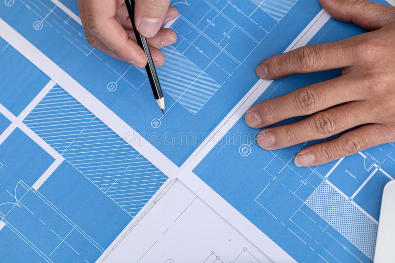 Architect Pointing To Building Plans for Review and Editing, Architect ...