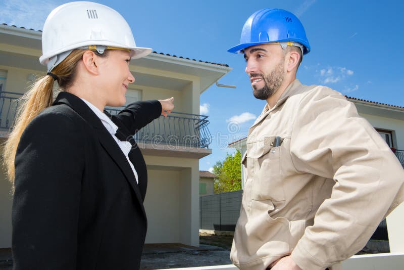 Architect Pointing To Construction Building Plan To Builder Stock Photo ...