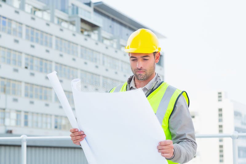 Architect Reading Blueprint Outside Building Stock Image - Image of ...