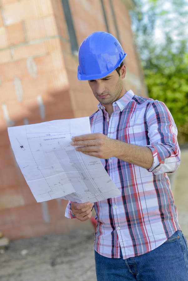 Architect Reading Blueprints on Site Stock Photo - Image of ...