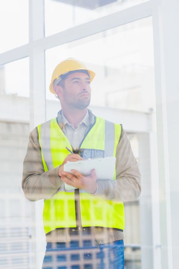 Architect in Reflective Clothing Writing on Clipboard at Office Stock ...